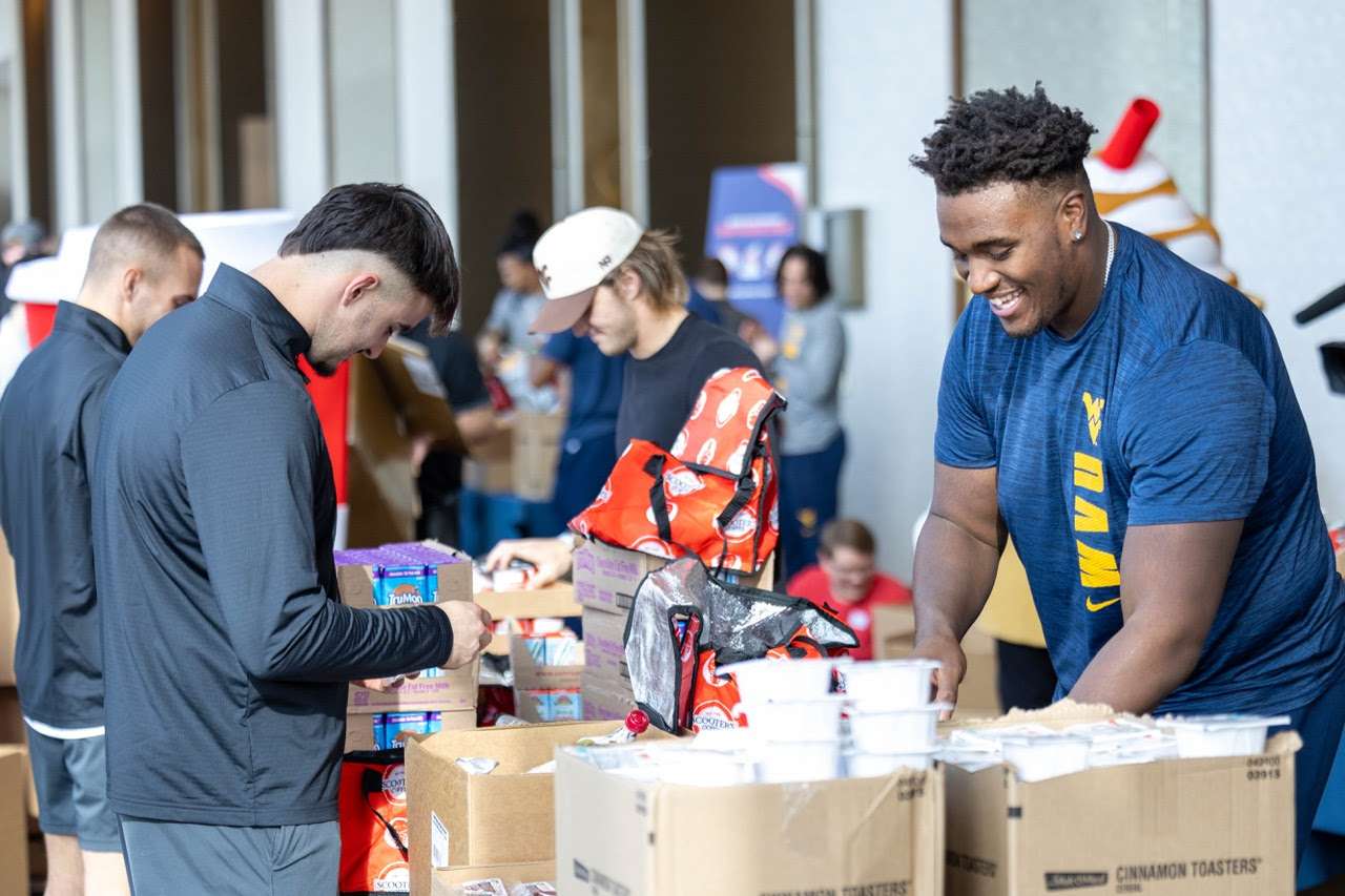 College Athletes Pack Lunches for Students in Need Ahead of Scooter’s ...
